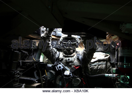 U.S. Army Specialist adjusts his gunner's safety harness prior to a ...