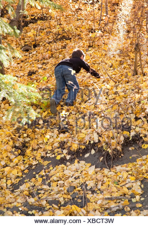 Boy climbing steep hill Stock Photo: 7670691 - Alamy