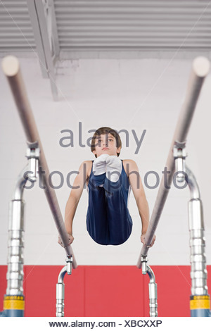Male gymnast on the parallel bars Stock Photo - Alamy
