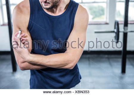 Muscle man injecting steroids into his strong arm using a syringe Stock ...