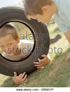 Two Boys playing on a Tire-Swing - Fun - Leisure Time - Playground ...