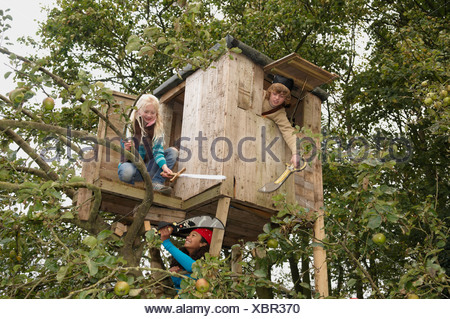 Girl climbing in treehouse outdoors Stock Photo: 72118713 - Alamy