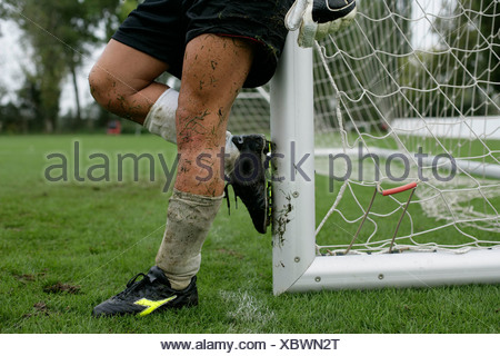 Goalkeeper at the goal post Stock Photo - Alamy