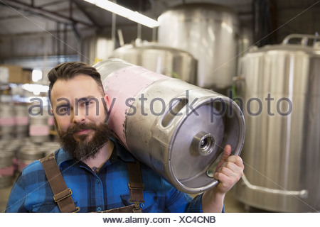 Man Carrying a Beer Keg on His Shoulder in a Brewery Stock Photo ...