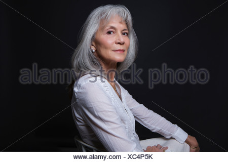 Studio portrait of aloof senior woman Stock Photo - Alamy