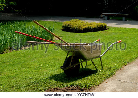 wheelbarrow with shovel and rake Stock Photo - Alamy