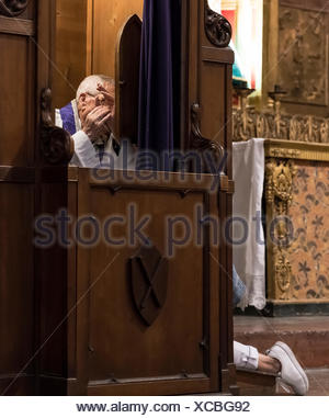 Catholic priest hearing a confession Stock Photo - Alamy