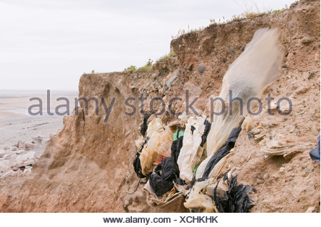 old landfill rubbish revealed in sea cliffs by coastal erosion on Stock ...