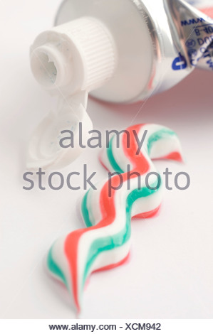 A crumpled tube of toothpaste, with white, green and red striped Stock ...
