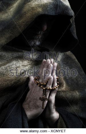 Christian human praying with rosary in hands Stock Photo: 49920416 - Alamy