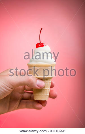 Pink ice cream cone with cherry Stock Photo: 140536140 - Alamy