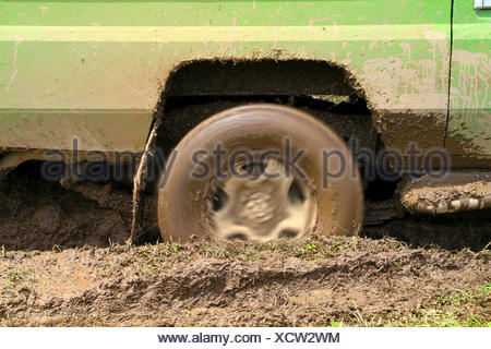 Close-up of car wheels spinning in the mud at a demolition derby Stock ...