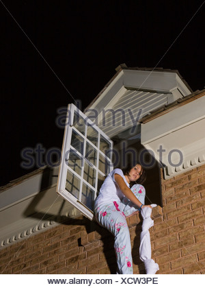 teenager climbing out of her bedroom window Stock Photo - Alamy