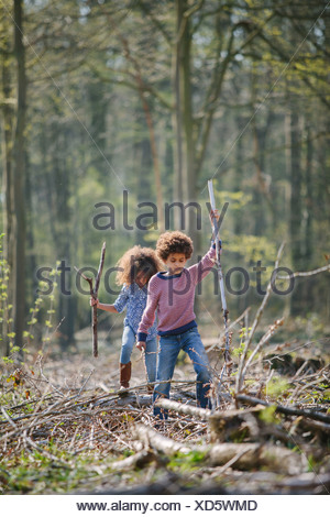 Brother (6-7) and sister (4-5) walking in forest Stock Photo: 78256674 ...