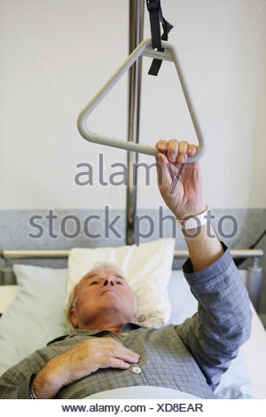 A man lies in a hospital bed with heart monitors to assess the risk ...