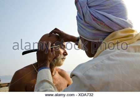 Shaving the head as part of a religious ritual, performed at Sangam ...