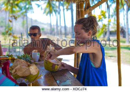 View of a young woman eating coconut Stock Photo: 80215820 - Alamy