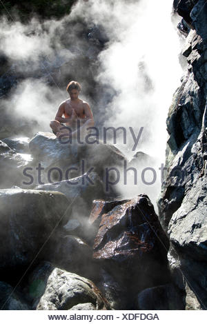 A visitor enjoys the steaming natural mineral hot springs at Hot ...