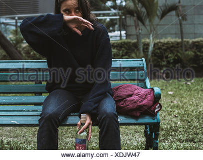 DRUNK HOMELESS WOMAN IN DESPAIR IN THE STREETS OF ROME WITH A BOTTLE ...
