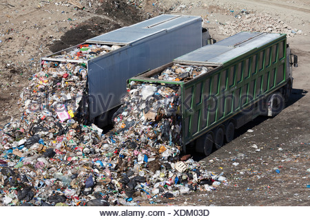 Trucks dumping waste in landfill Stock Photo - Alamy