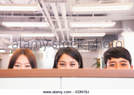 People peeking over cubicle in office Stock Photo: 72126175 - Alamy
