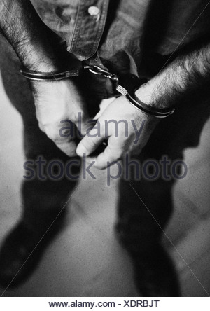 Man wearing handcuffs, close-up, b&w Stock Photo: 5436245 - Alamy