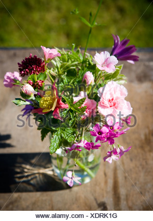Mixed summer flowers in a glass jam jar vase Stock Photo: 13937195 - Alamy