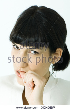 Close up of woman biting thumb Stock Photo: 12908473 - Alamy