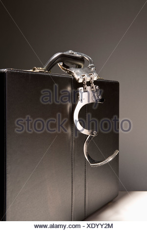 Handcuffs Attached to Briefcase Stock Photo: 5027720 - Alamy