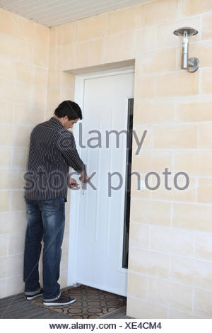 Man locking / unlocking front door of property Stock Photo: 39700316 ...