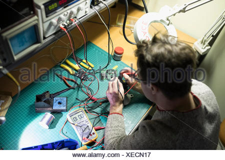 Mid adult electrical engineer working in manufacturing plant Stock ...
