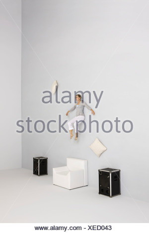 Woman with listening to music through speakers, floating in midair ...