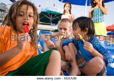 Girls at water park eating popsicles Stock Photo - Alamy
