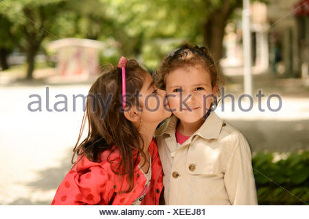 Friends hugging and kissing on cheek Stock Photo: 62474201 - Alamy