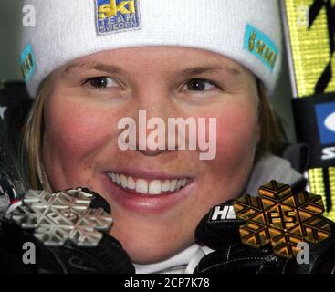 Anja Paerson, of Sweden, shows her medals after completing the Nations ...