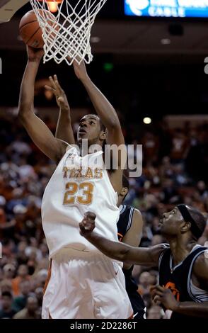 Oklahoma State forward Mario Boggan, left, deflects a shot by Mercer ...