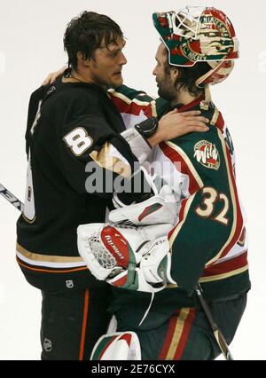 Minnesota Wild goalie Niklas Backstrom, right, of Finland, attempts to ...