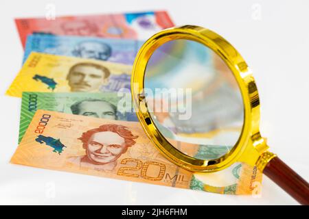 Costa Rica Geld, flaches Lay, alle Banknoten ausgeklappt, Lupe, weißer ...