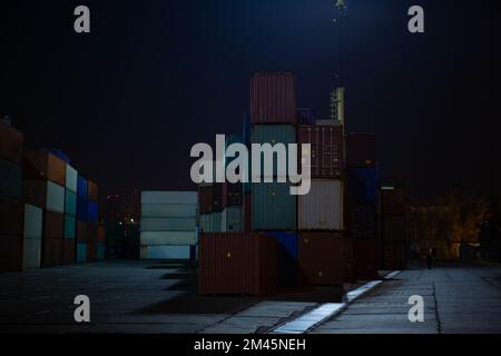 Stapel von Containern. Betrieb des Containerterminals bei Nacht. Das ...