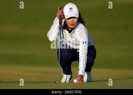 Xiyu Lin, of China, lines up her putt on the second hole during the ...