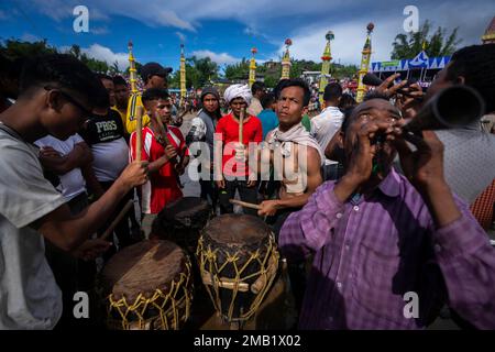 Pnar, or Jaintia, tribals carry 'Rongs' or chariots and dance in muddy ...