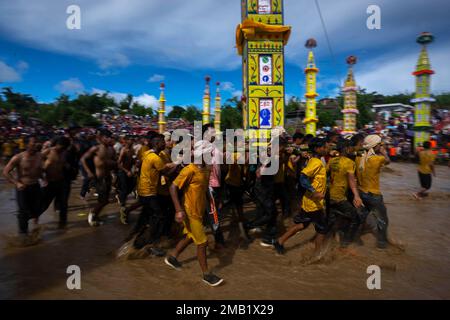 Pnar, or Jaintia, tribals carry 'Rongs' or chariots and dance in muddy ...
