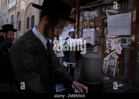 An ultra-Orthodox Jewish man dips cooking utensils in boiling water to ...