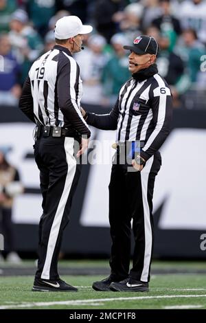 Referee Clay Martin (19) talks with side judge Dave Hawkshaw (107) and ...