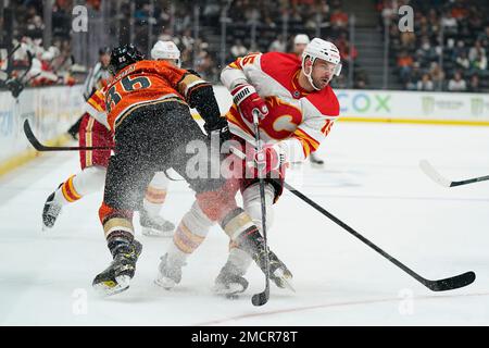Anaheim Ducks' Simon Benoit, left, watches a shot by Toronto Maple ...