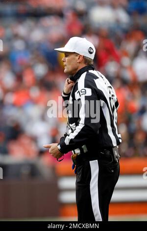 Referee Clay Martin (19) talks with side judge Dave Hawkshaw (107) and ...