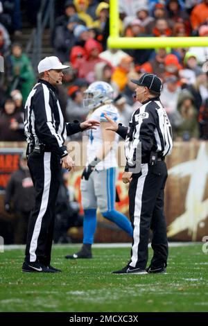 Referee Clay Martin (19) talks with side judge Dave Hawkshaw (107) and ...
