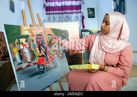 Somali artist Sana Ashraf Sharif Muhsin, 21, sits with some of her ...