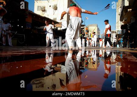 EDS NOTE: GRAPHIC CONTENT - Shiite faithful cut themselves with swords ...