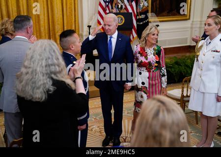 President Joe Biden salutes Air Force Lt. Col. Bree Fram after speaking ...